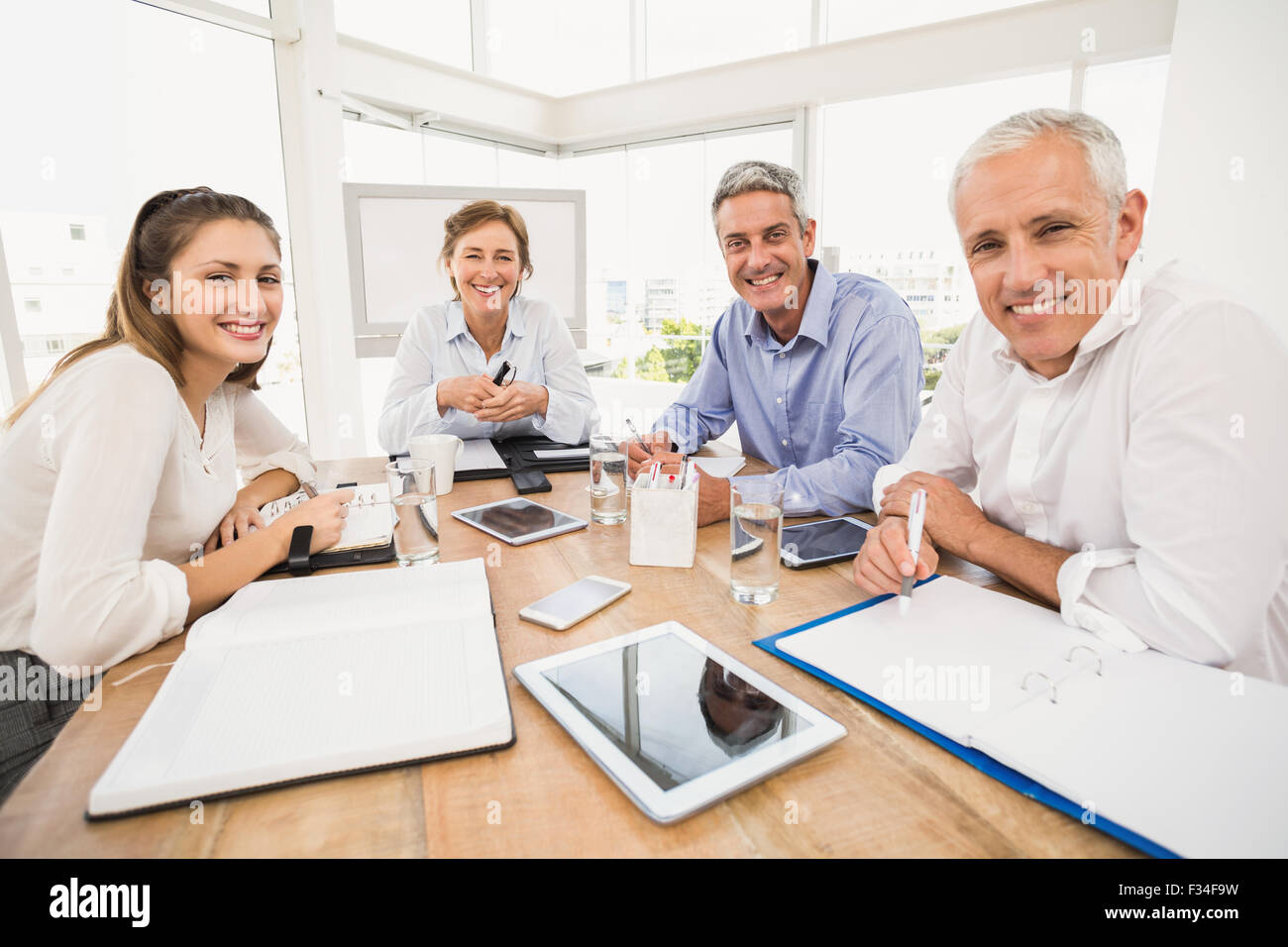 Smiling business people during a meeting Stock Photo - Alamy