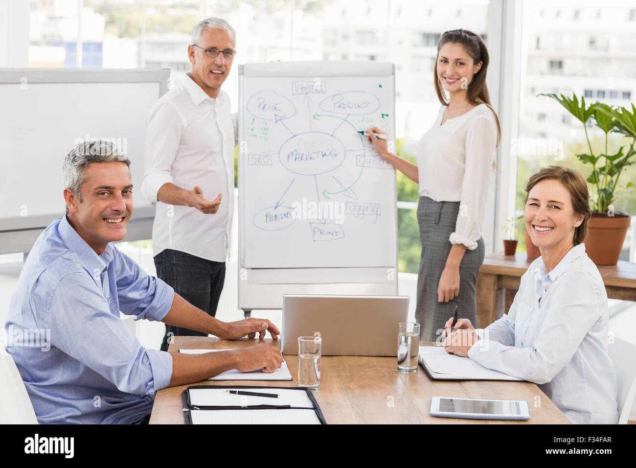 Smiling business people having a meeting Stock Photo - Alamy