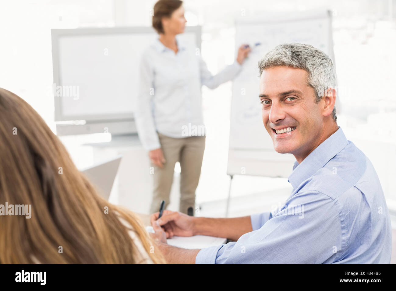 Smiling businessman during a meeting Stock Photo - Alamy