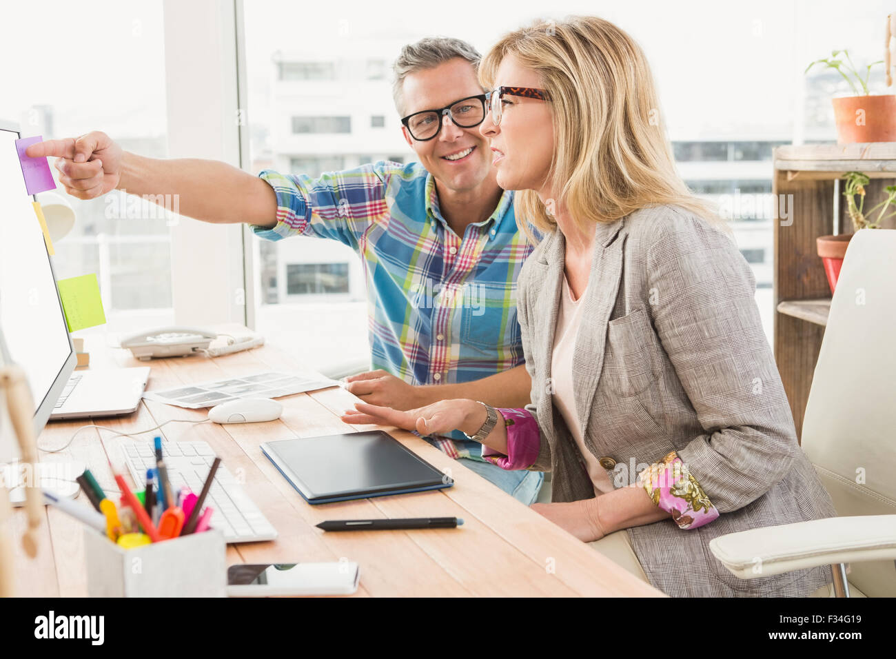 Creative design team working together on computer Stock Photo - Alamy