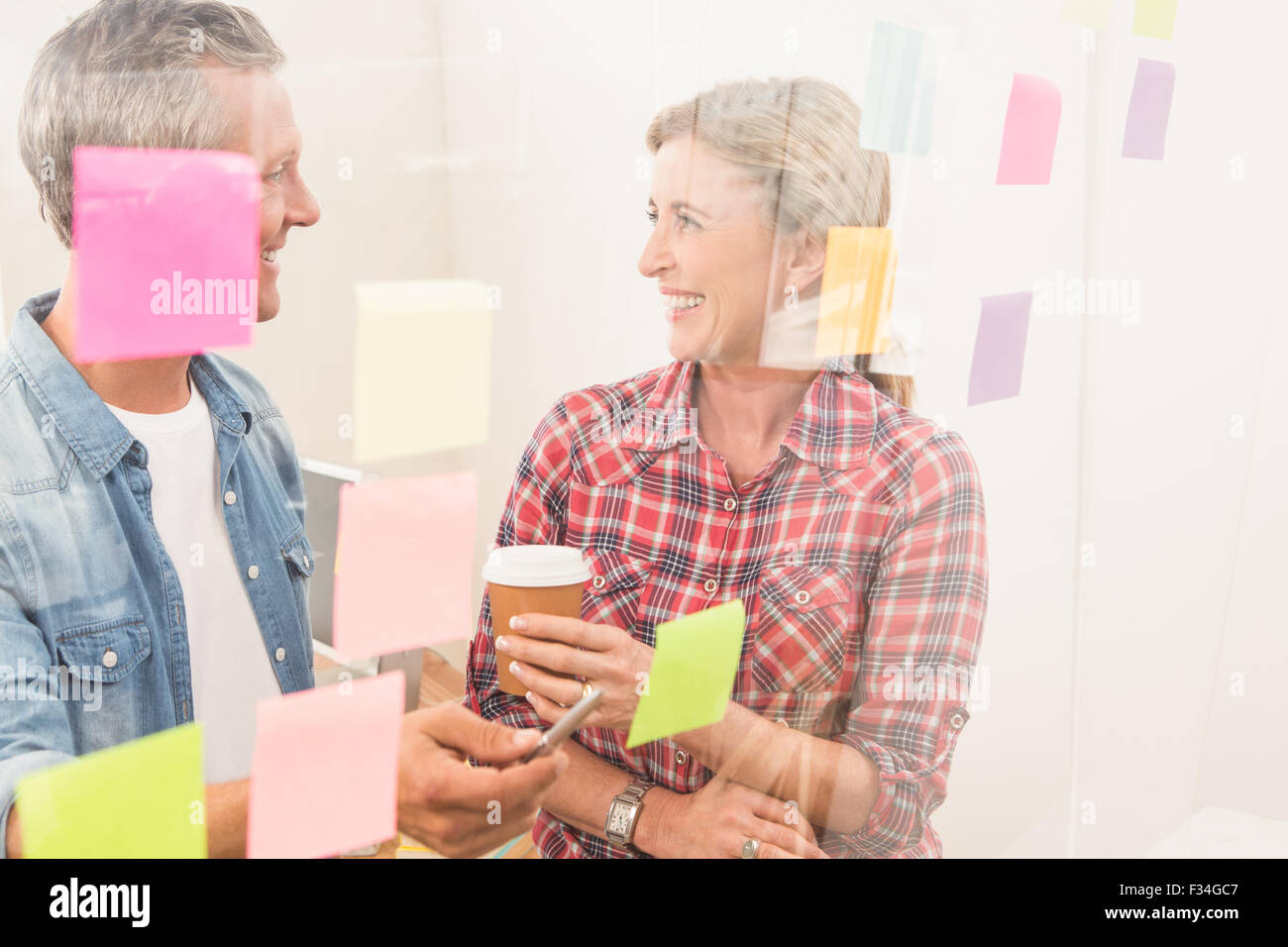 Casual business colleagues laughing at work Stock Photo - Alamy