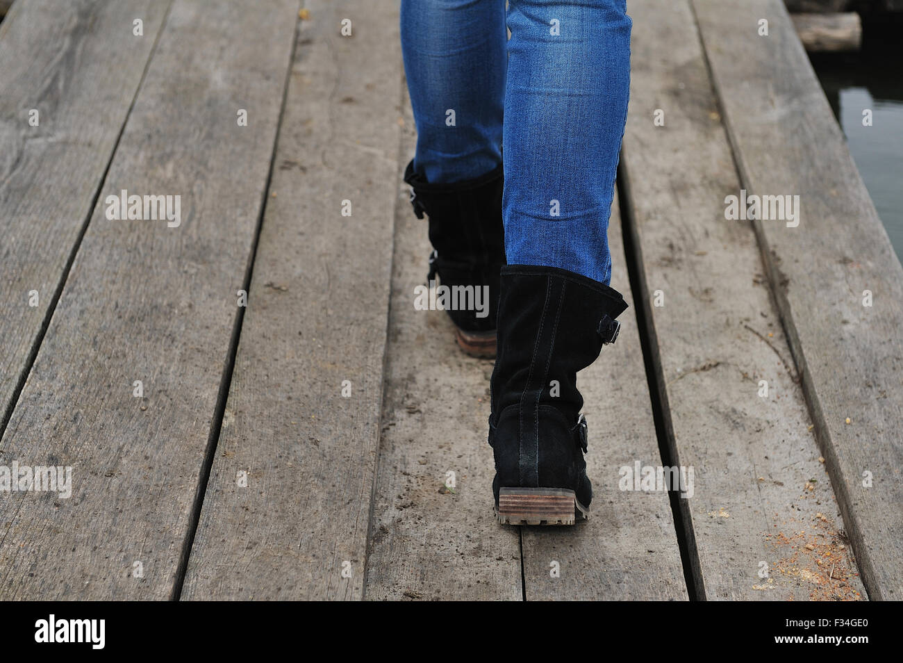 Feet on the old wooden bridge Stock Photo - Alamy