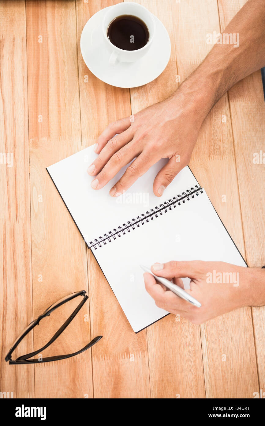 Hands writing on notepad Stock Photo - Alamy