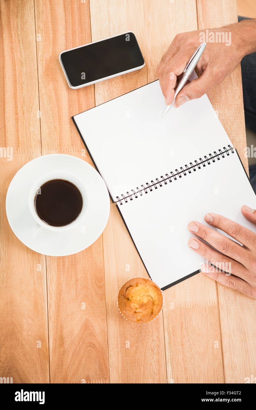 Hands writing on notepad Stock Photo - Alamy