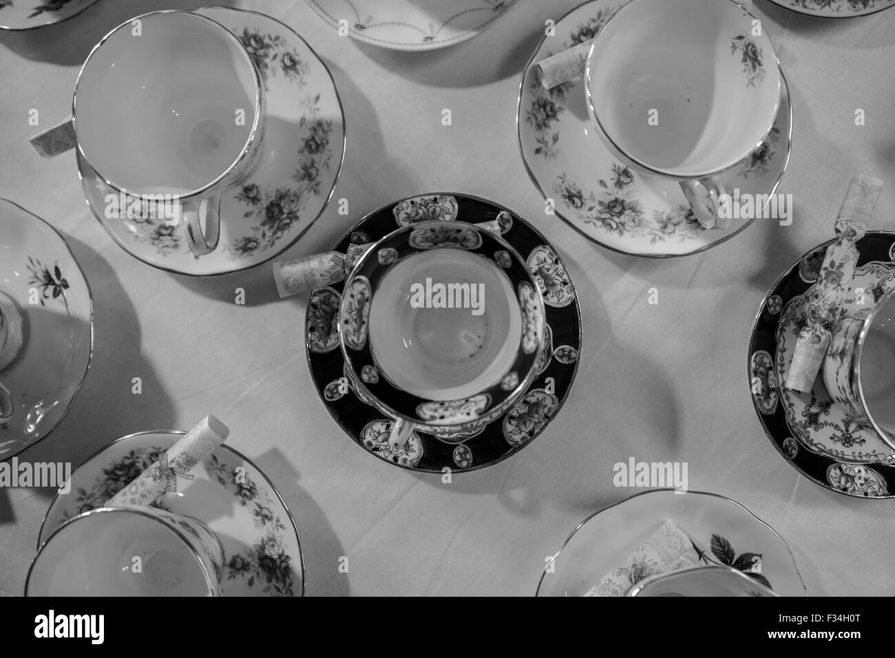 View from above of tea cups laid out of afternoon tea in black and ...