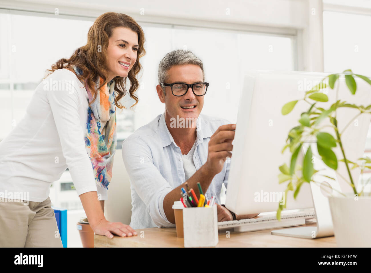 Two casual designers working with computer Stock Photo - Alamy