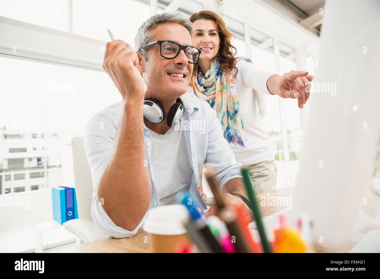 Two casual designers working with computer Stock Photo - Alamy