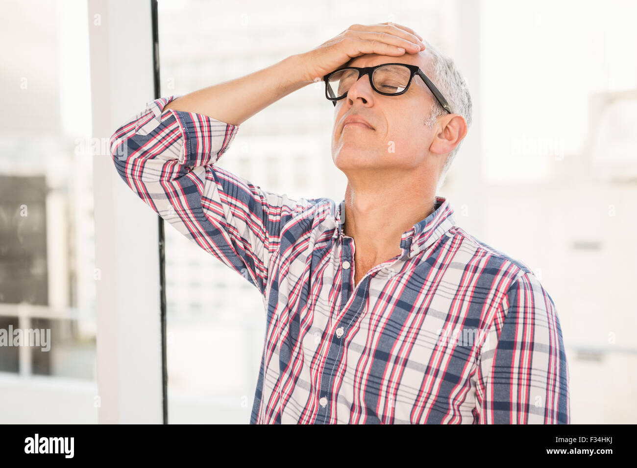 Worried creative businessman leaning hi-res stock photography and ...
