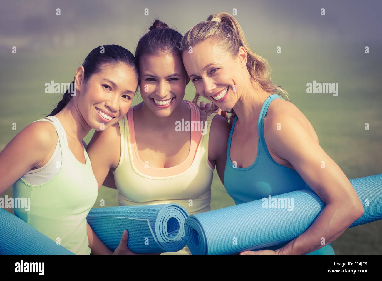 Laughing sporty women with exercise mats Stock Photo - Alamy