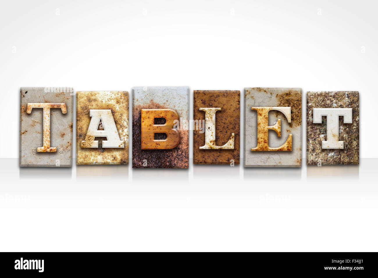 The word "TABLET" written in rusty metal letterpress type isolated on a ...