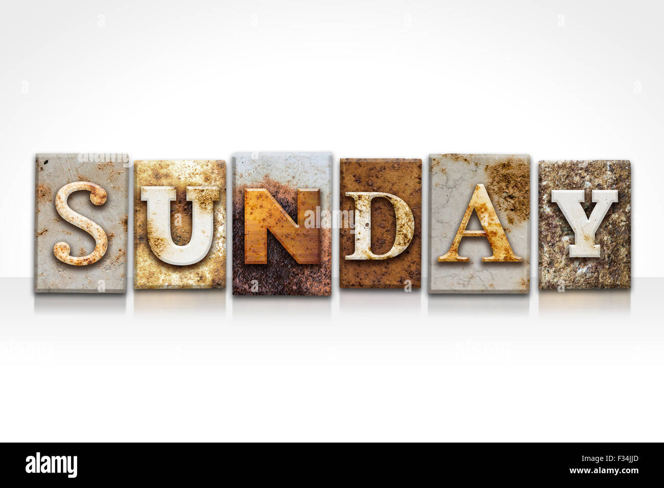 The word "SUNDAY" written in rusty metal letterpress type isolated on a ...
