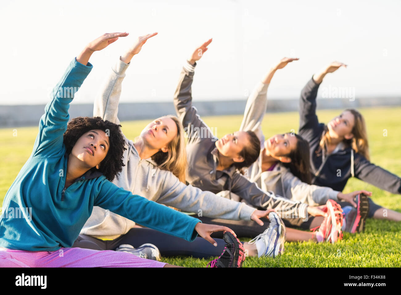 Sporty women stretching during fitness class Stock Photo - Alamy
