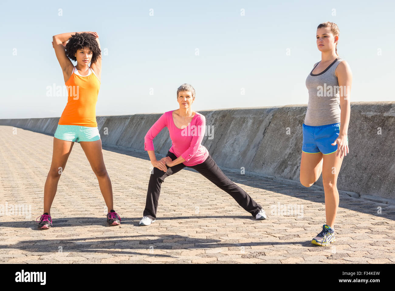 Sporty women stretching together Stock Photo - Alamy