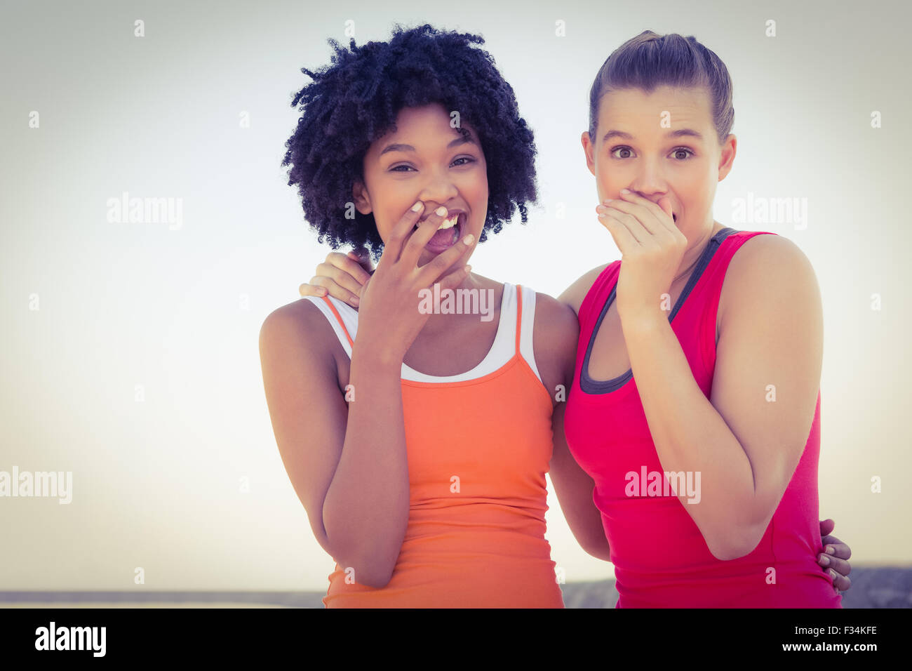 Two young women laughing to camera Stock Photo - Alamy