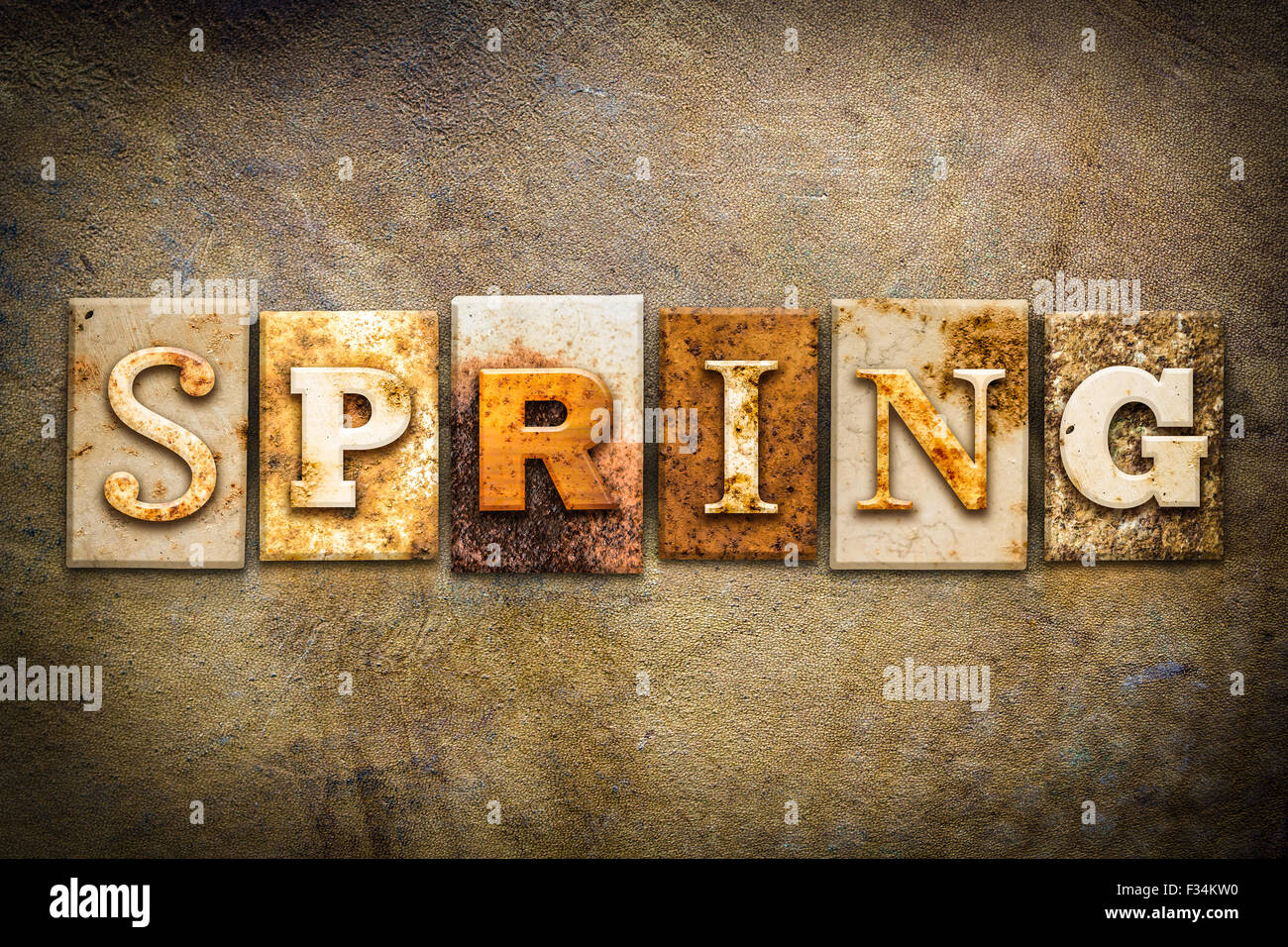 The word "SPRING" written in rusty metal letterpress type on an old ...