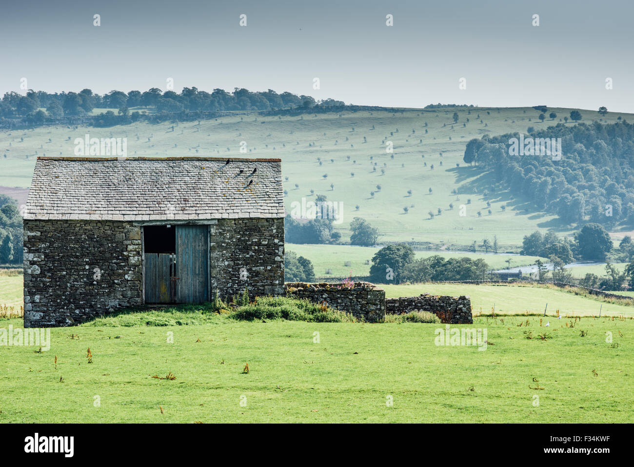 Old Cumbrian stone barn in the summer near the River Lowther at Helton ...