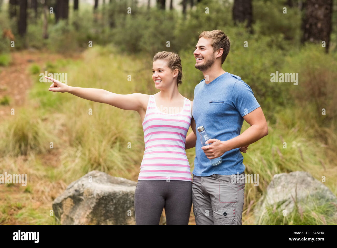 Young happy woman pointing in the distance next to her friend Stock ...