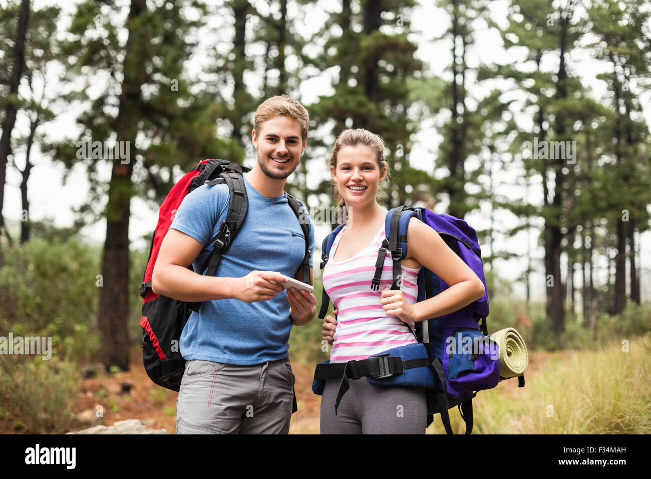 Portrait of young happy hikers Stock Photo - Alamy
