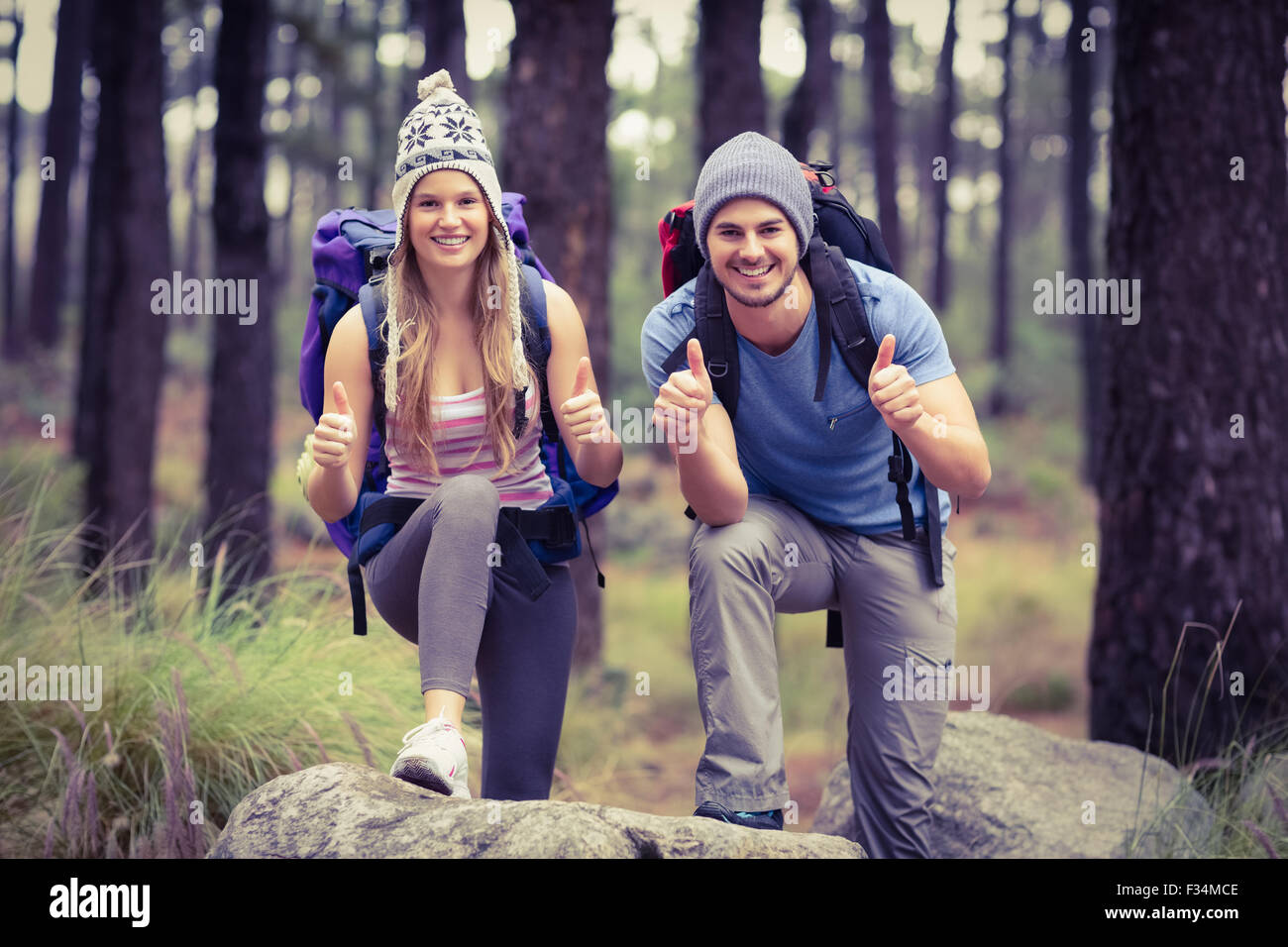 Portrait of a happy hiker couple with thumbs up Stock Photo - Alamy