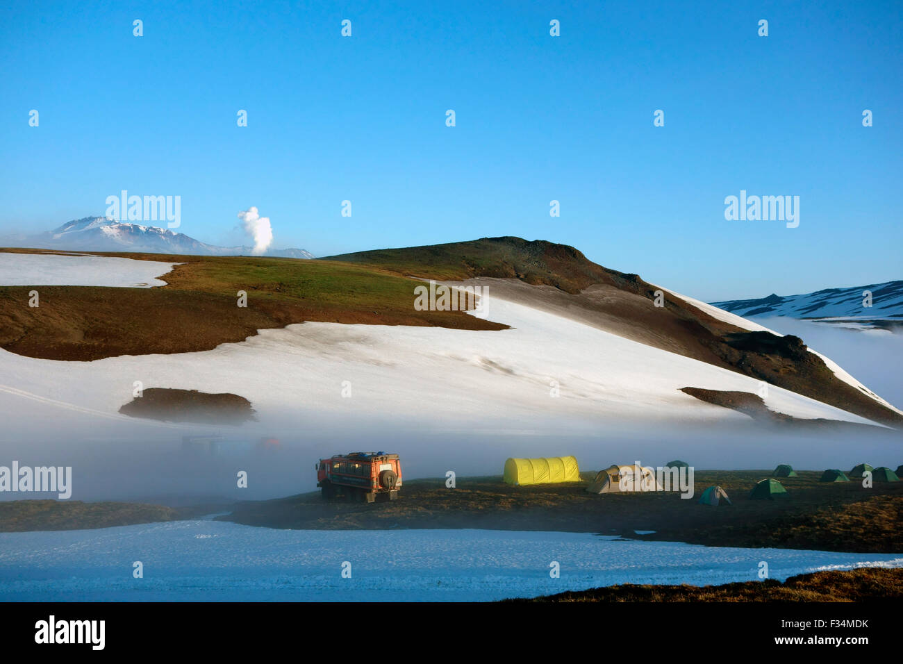Camping below Gorely volcano with the smoking Mutnovsky volcano at the ...