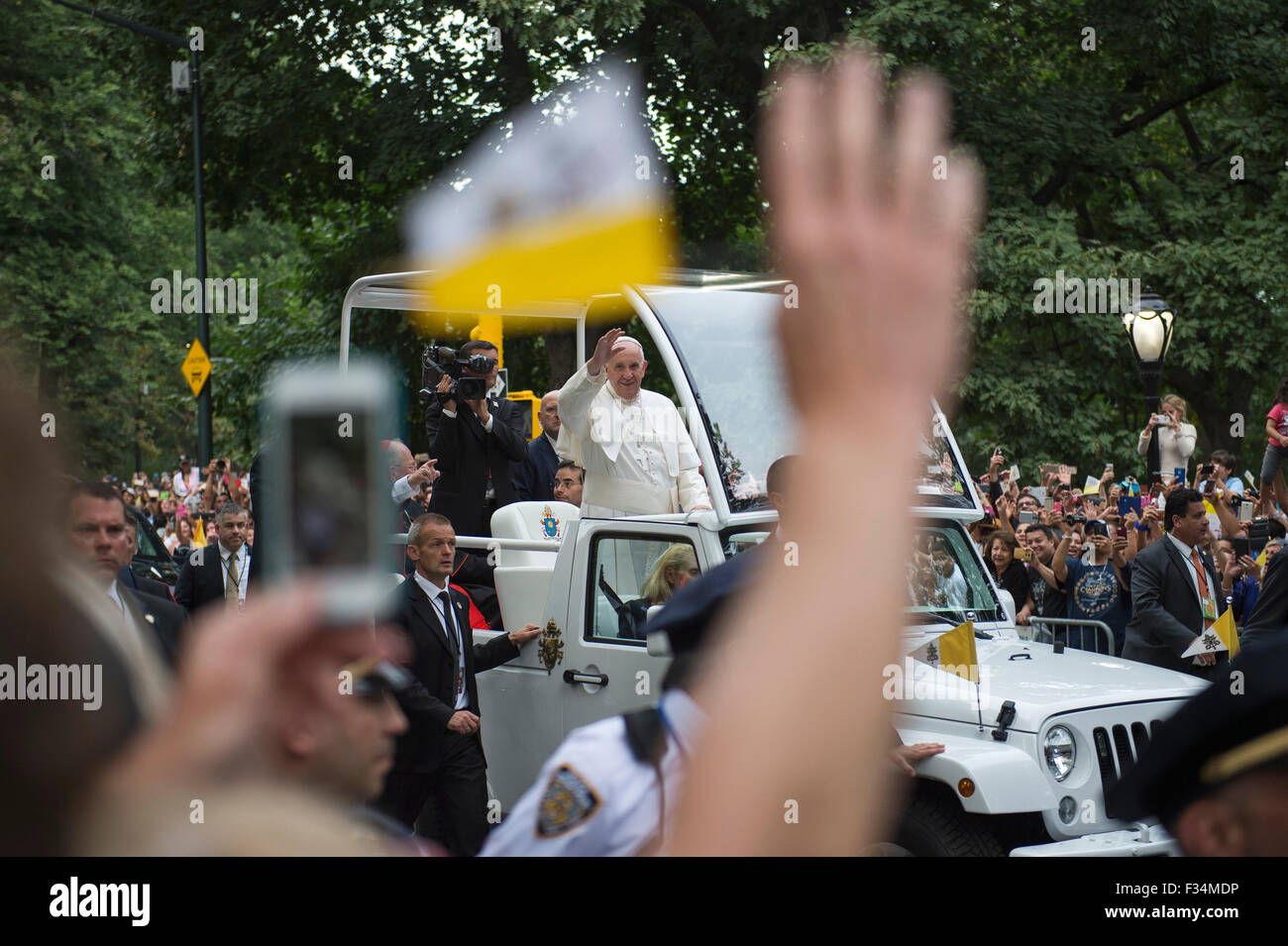 Pope Francis waves as he rides in the popemobile motorcade through ...