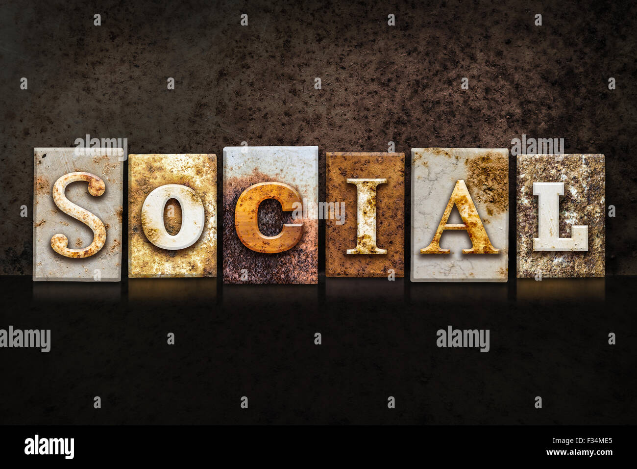 The word "SOCIAL" written in rusty metal letterpress type on a dark ...