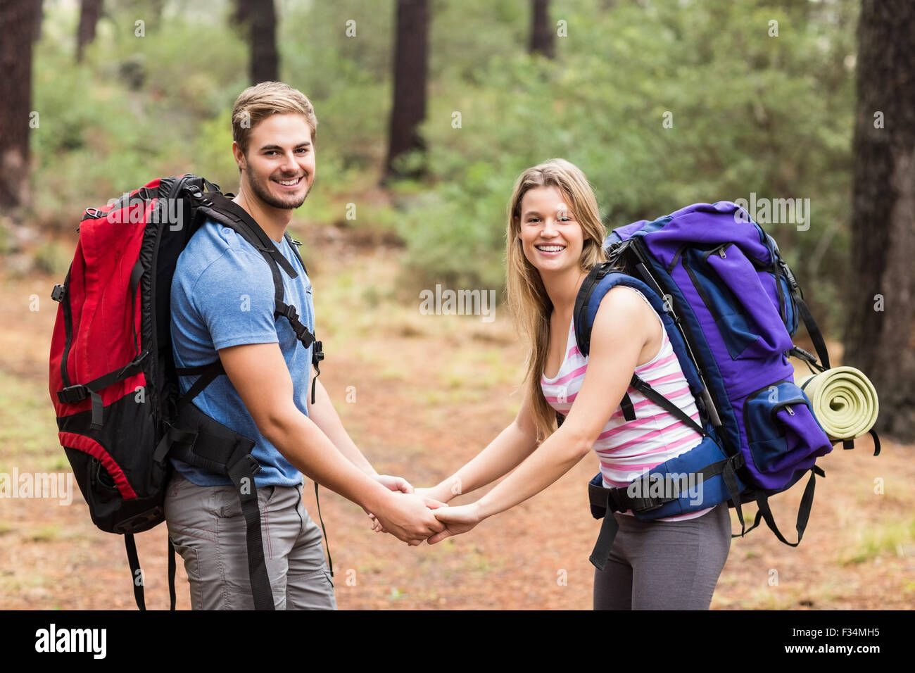Young happy hiker couple holding hands Stock Photo - Alamy