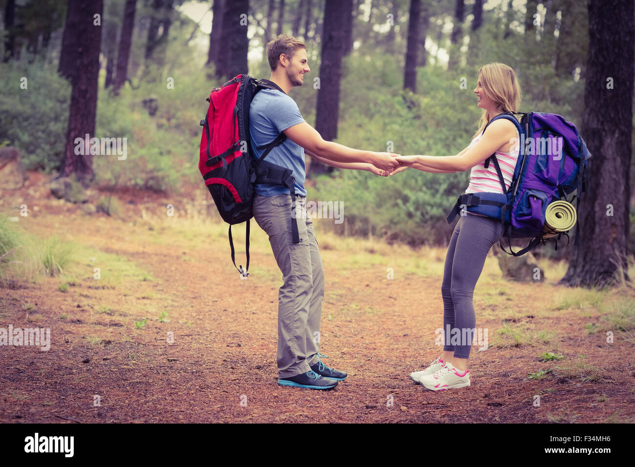 Young happy hiker couple holding hands Stock Photo - Alamy