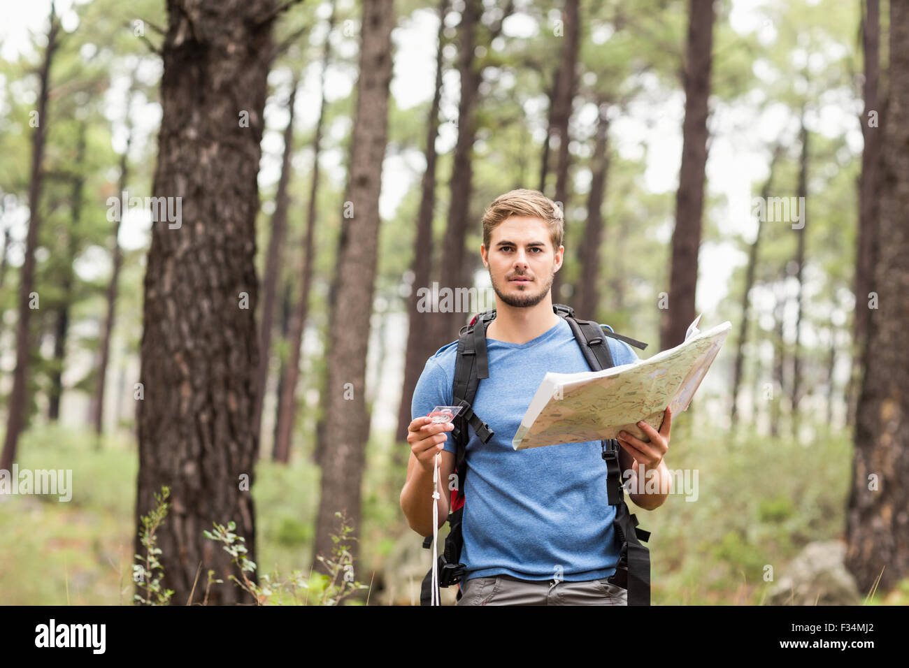 Young handsome hiker using map Stock Photo - Alamy