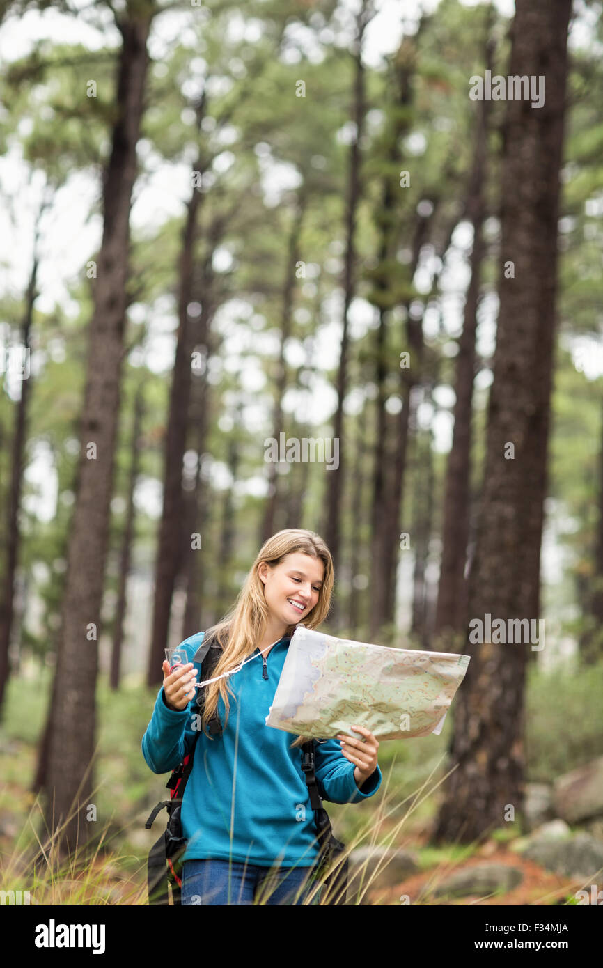 Young pretty hiker using compass and map Stock Photo - Alamy