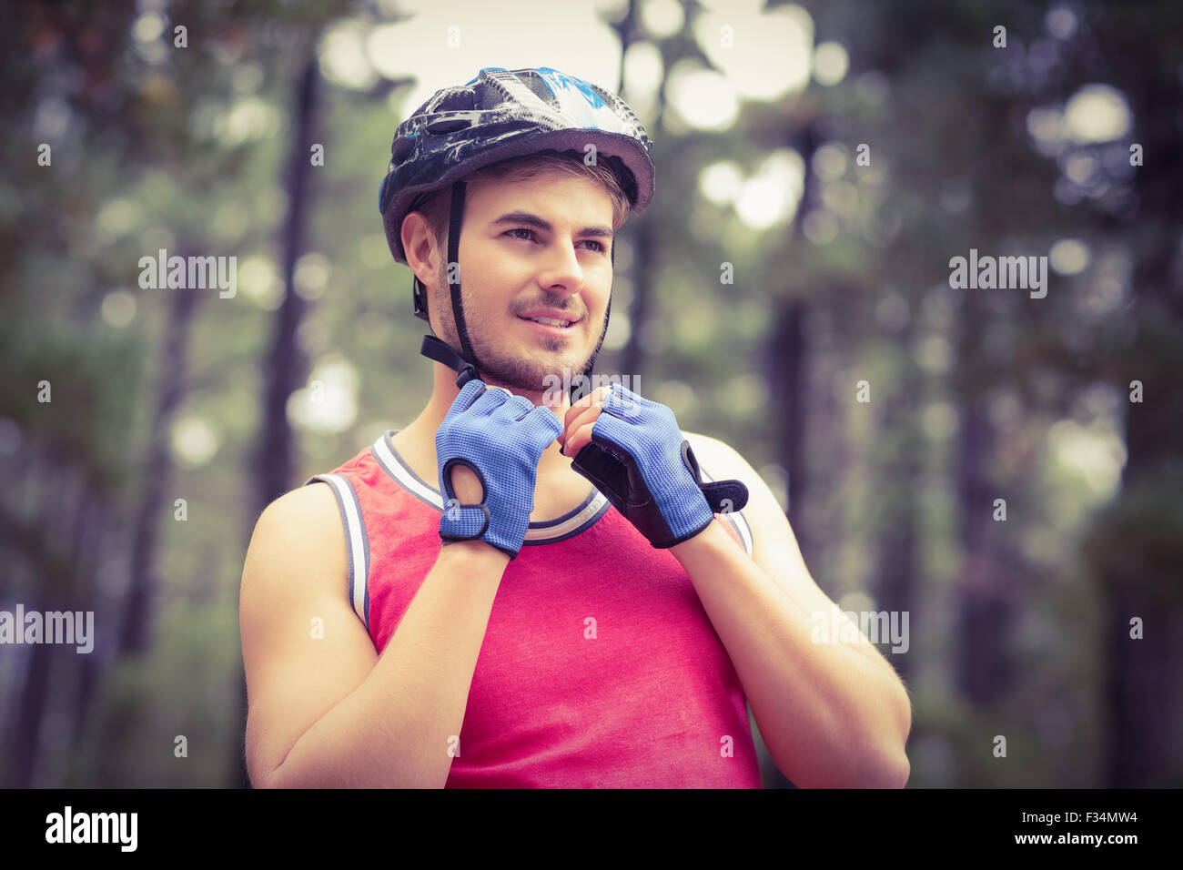 Handsome young biker looking away Stock Photo - Alamy