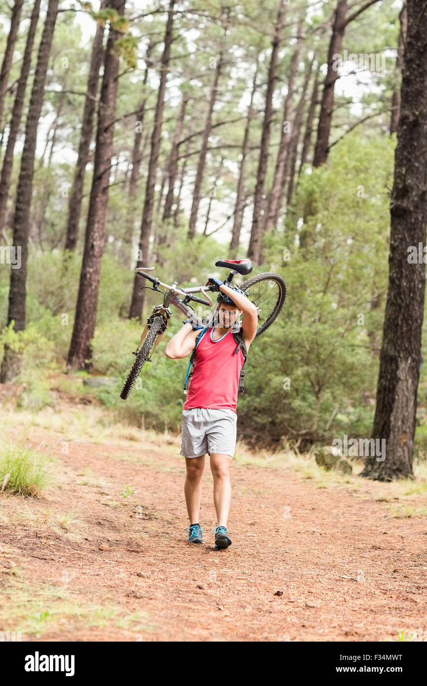 Happy handsome biker holding bike Stock Photo - Alamy