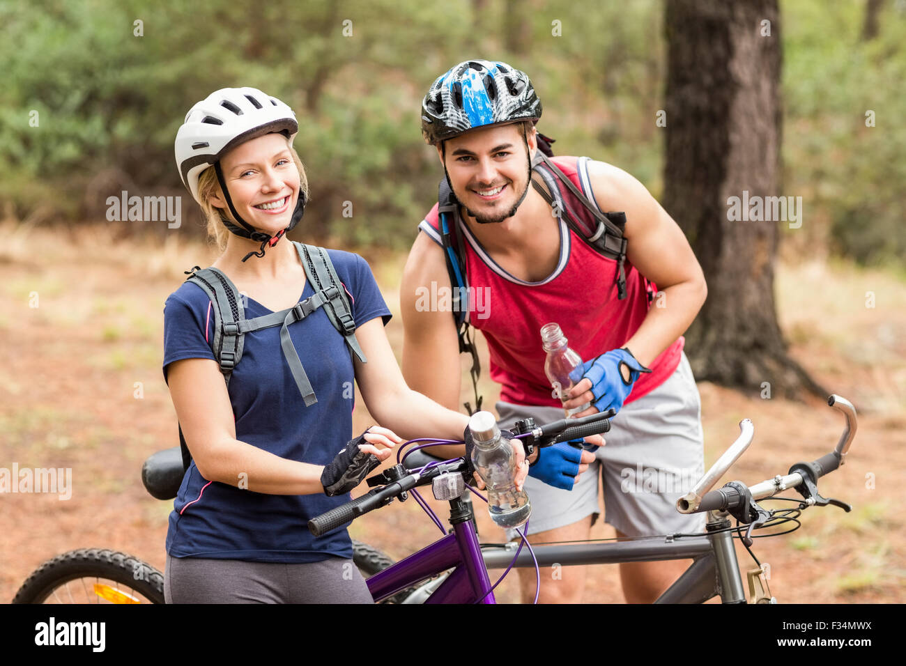 Happy handsome biker couple looking at camera Stock Photo - Alamy