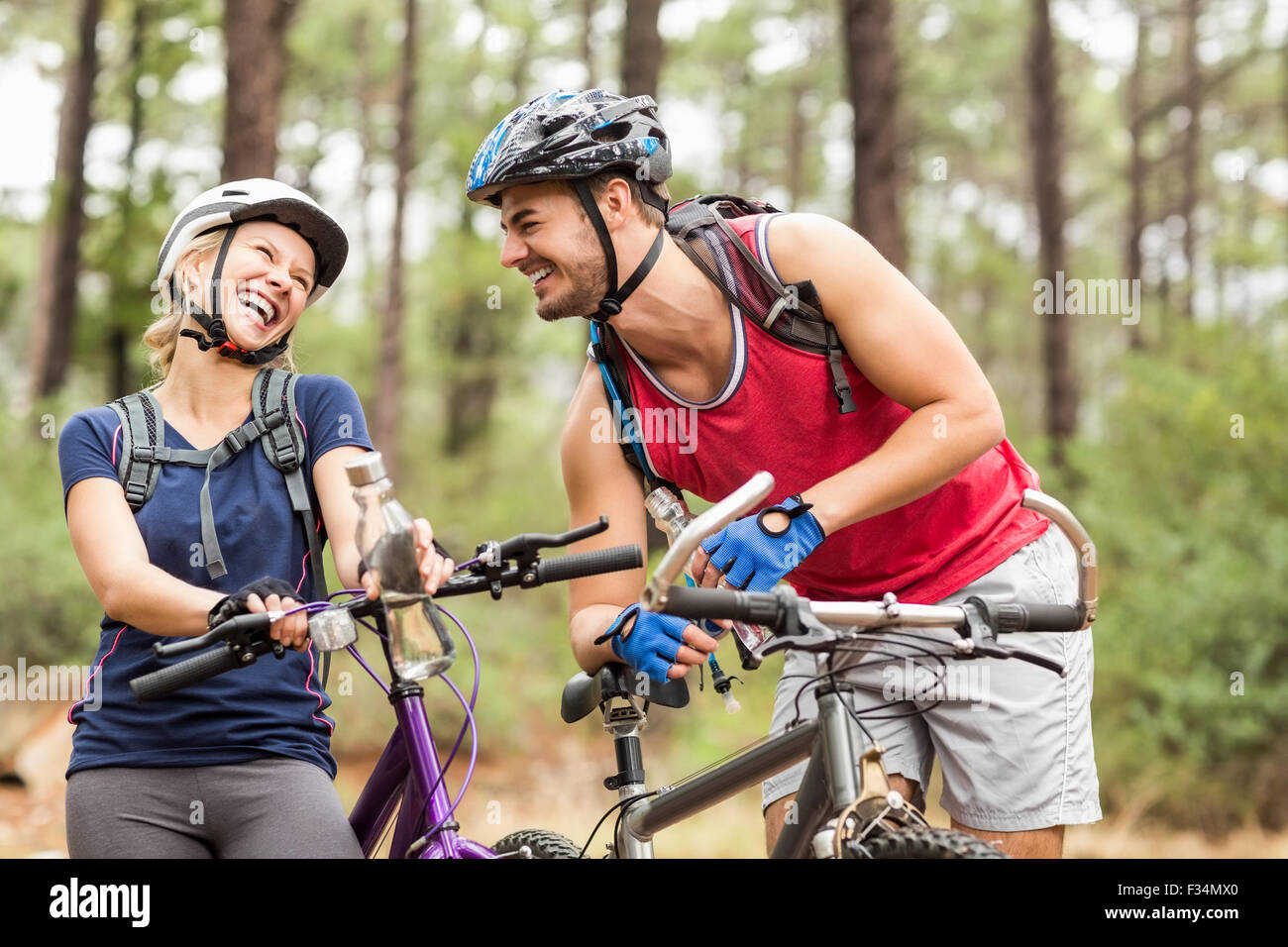 Happy handsome biker couple laughing Stock Photo - Alamy