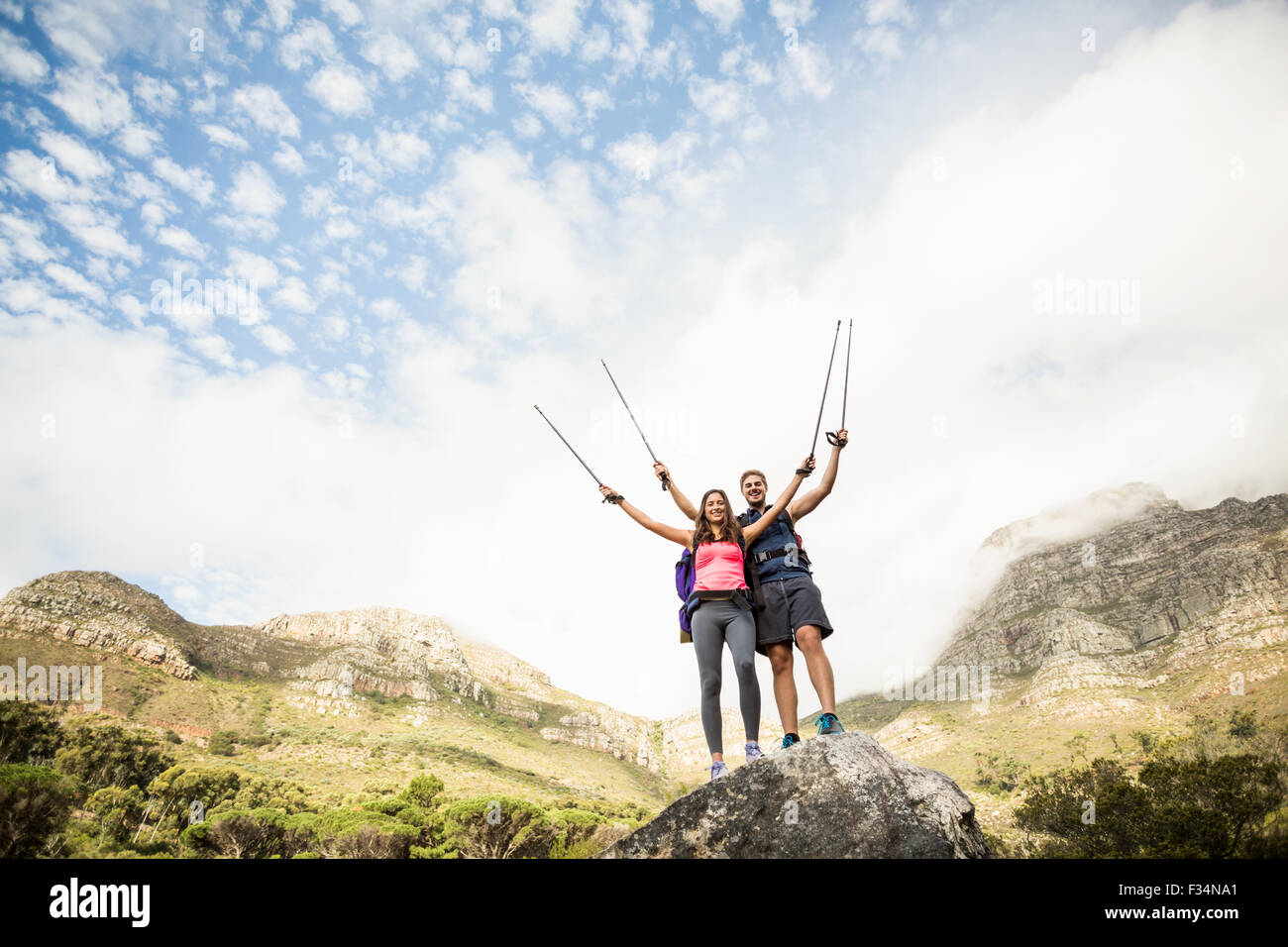 Young happy joggers standing on rock cheering Stock Photo - Alamy