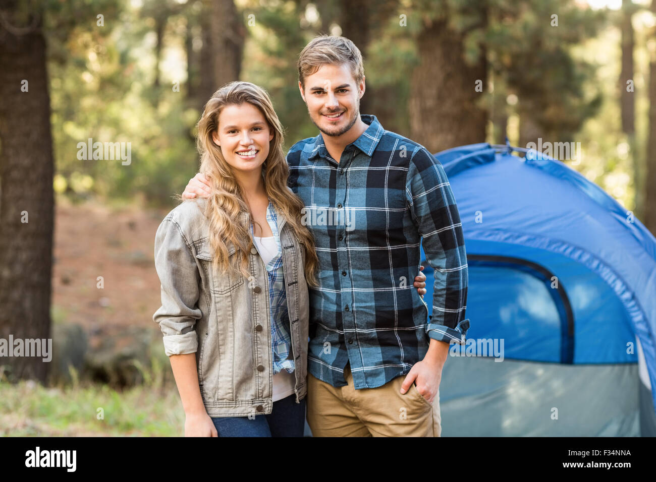 Happy young camper couple looking at the camera Stock Photo - Alamy