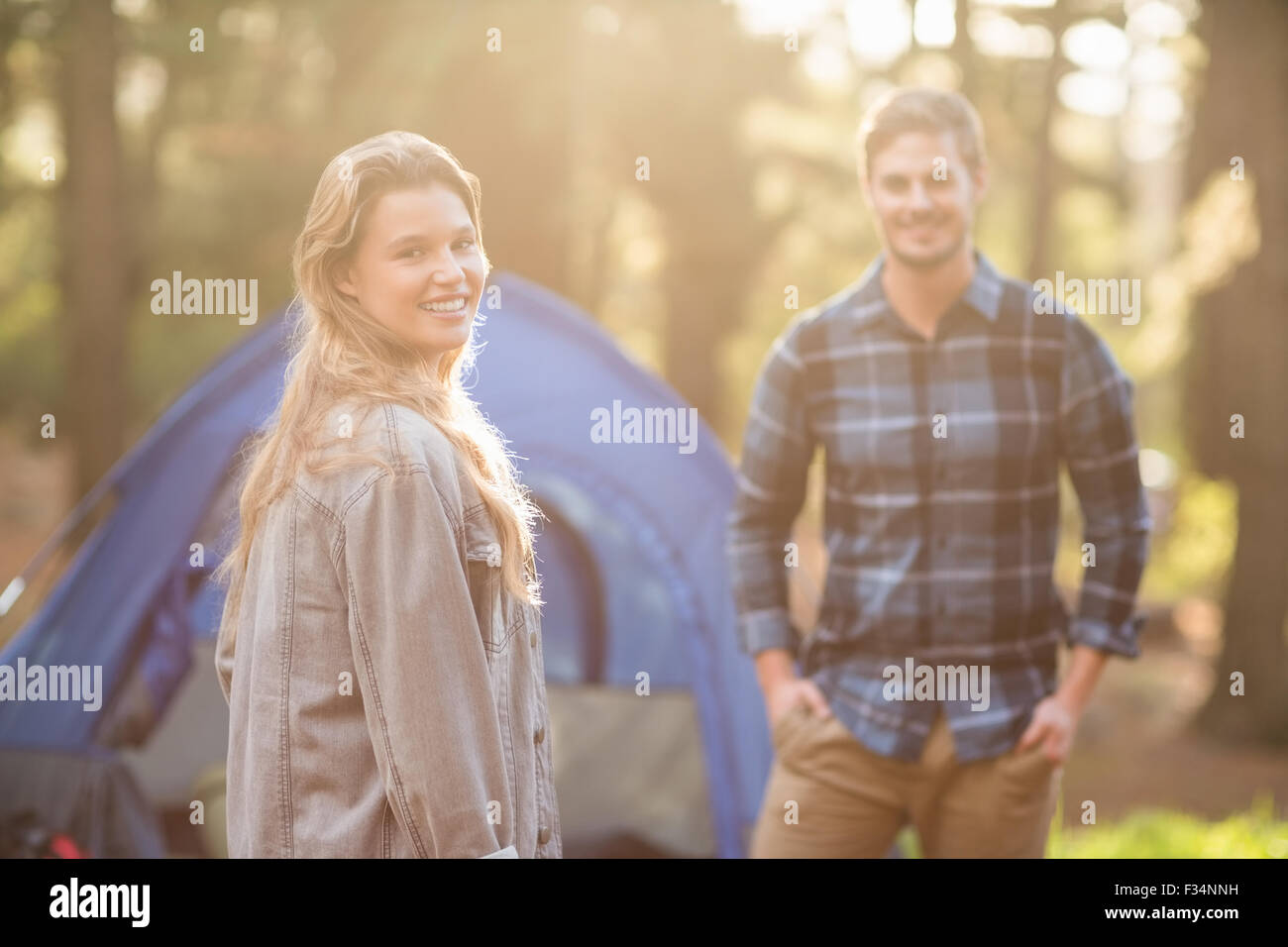 Happy young camper couple smiling Stock Photo - Alamy