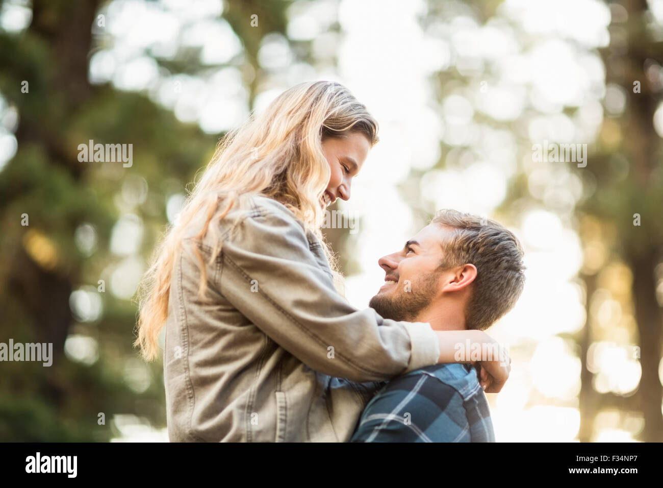 Smiling handsome man holding his girlfriend Stock Photo - Alamy