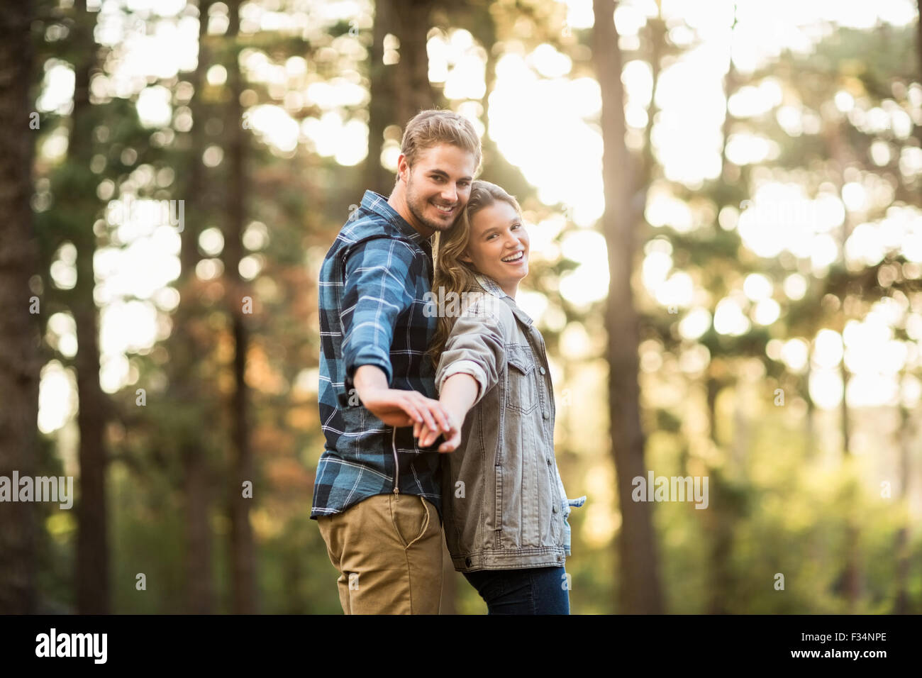 Happy smiling couple standing behind each other Stock Photo - Alamy