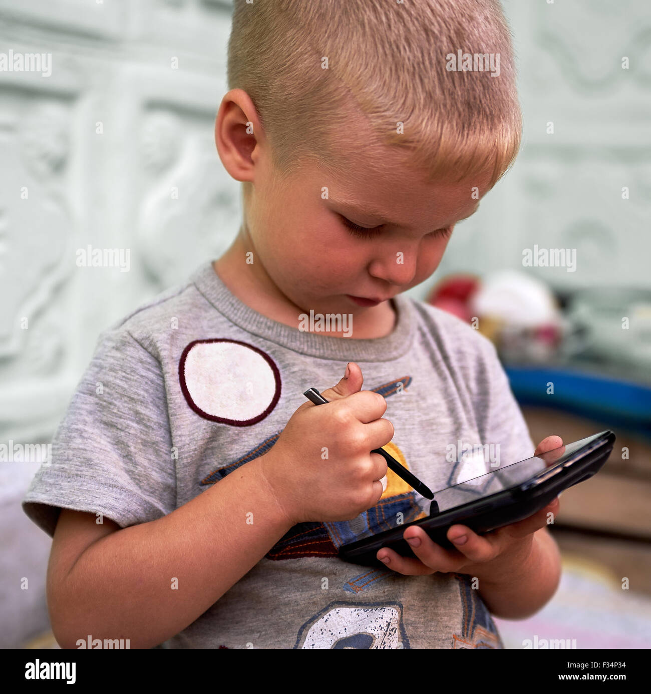 Little boy plays with smartphone Stock Photo - Alamy