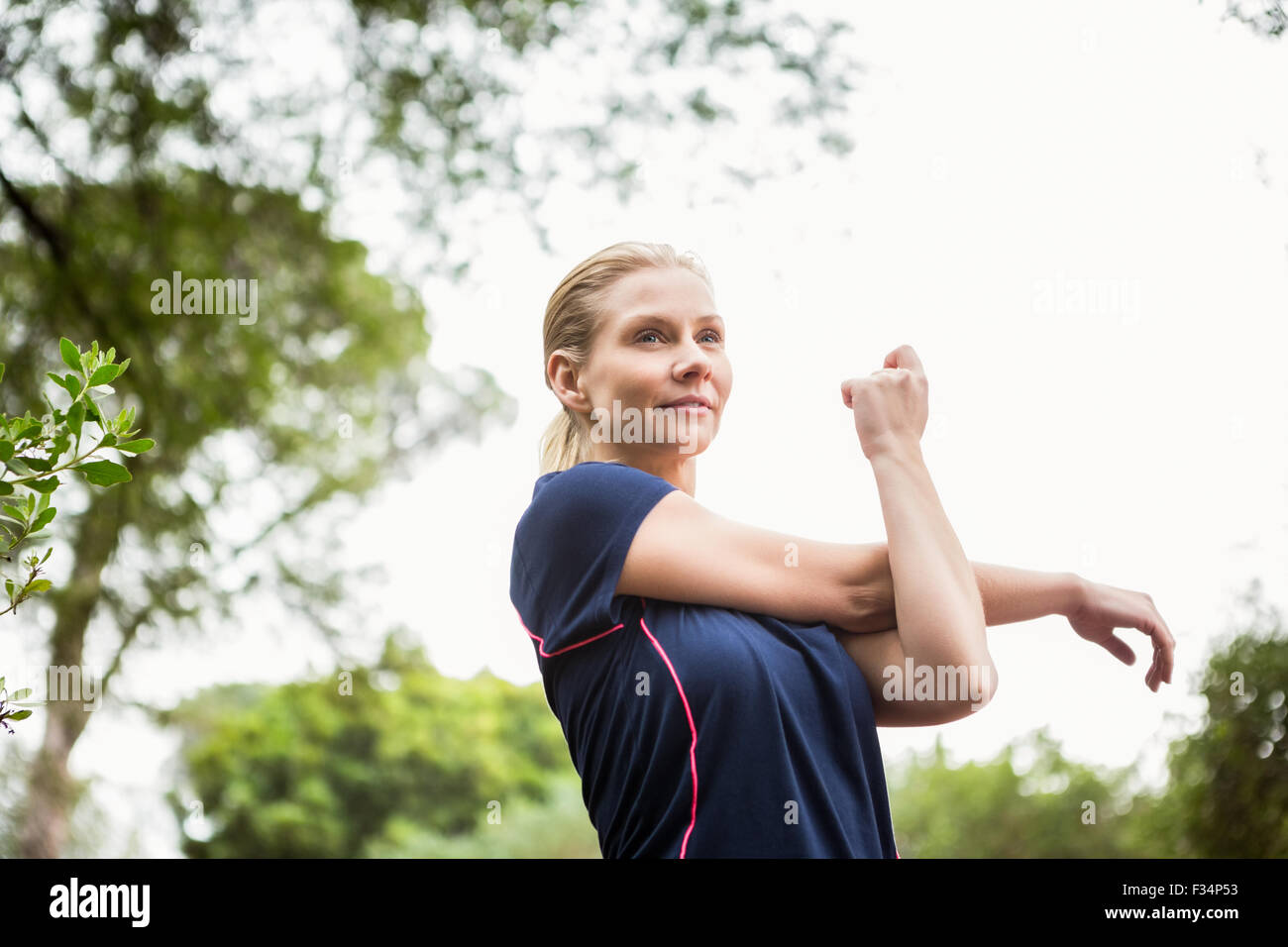 Athletic woman doing arms stretching Stock Photo - Alamy