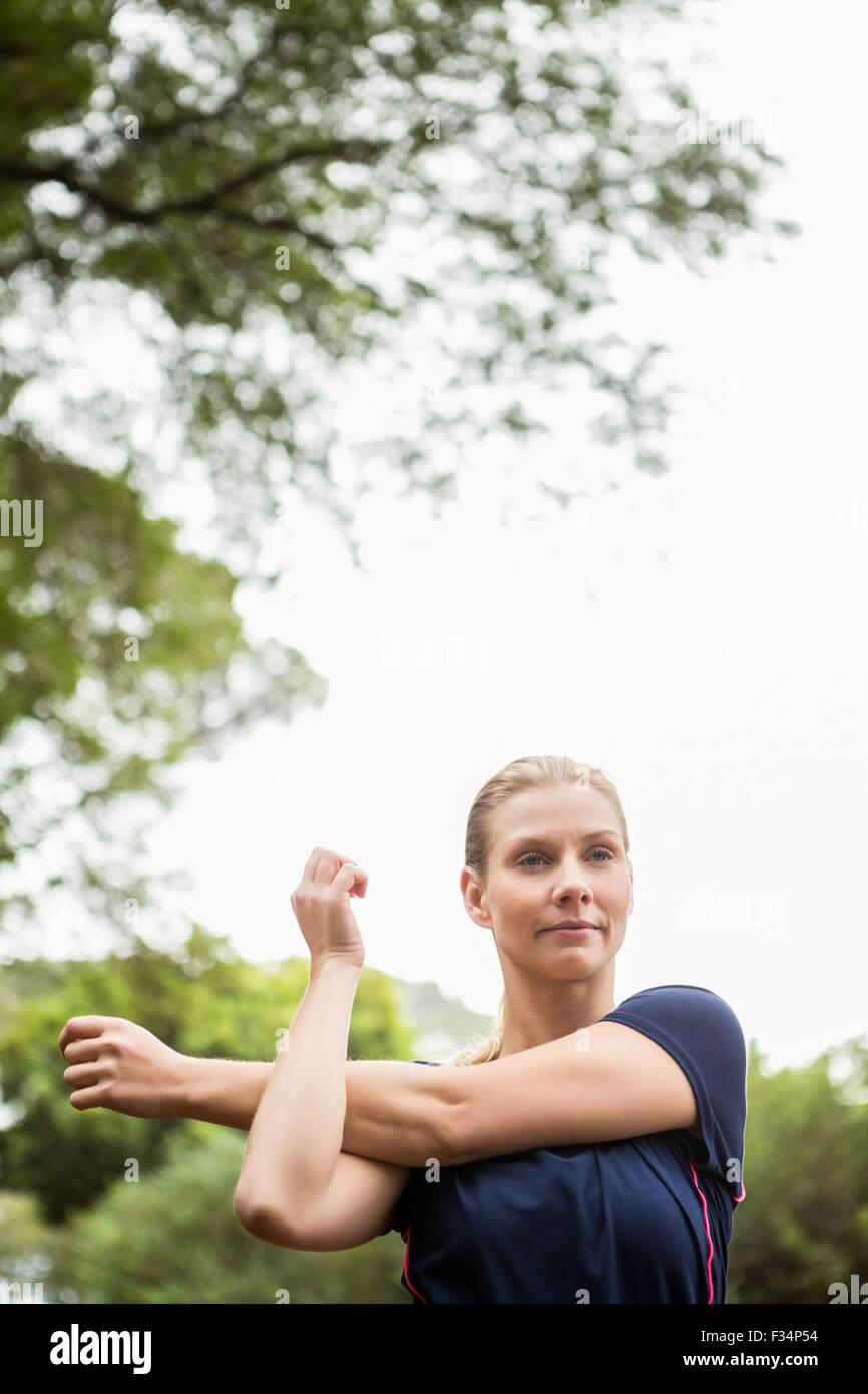 Athletic woman doing arms stretching Stock Photo - Alamy