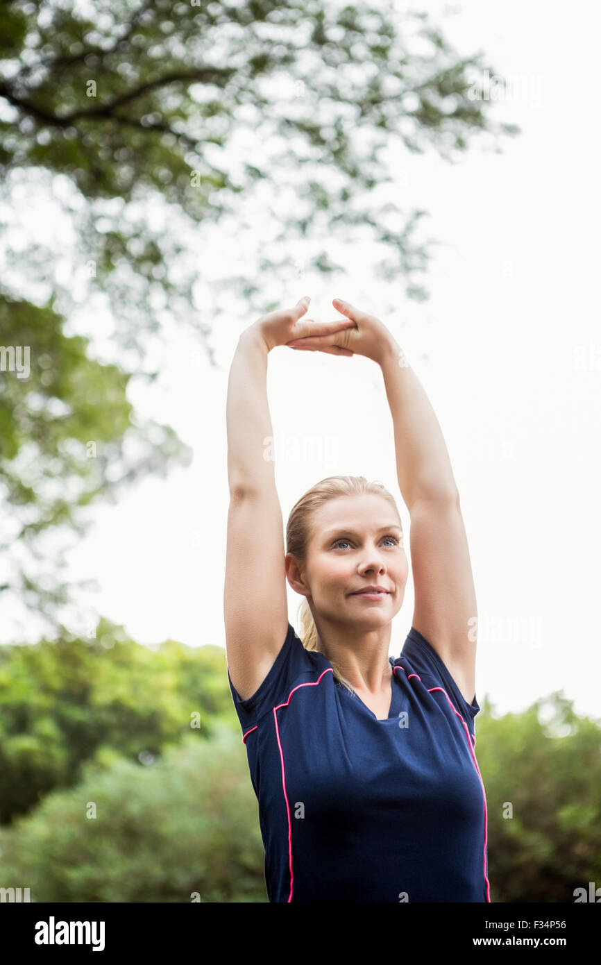 Athletic woman doing arms stretching Stock Photo - Alamy