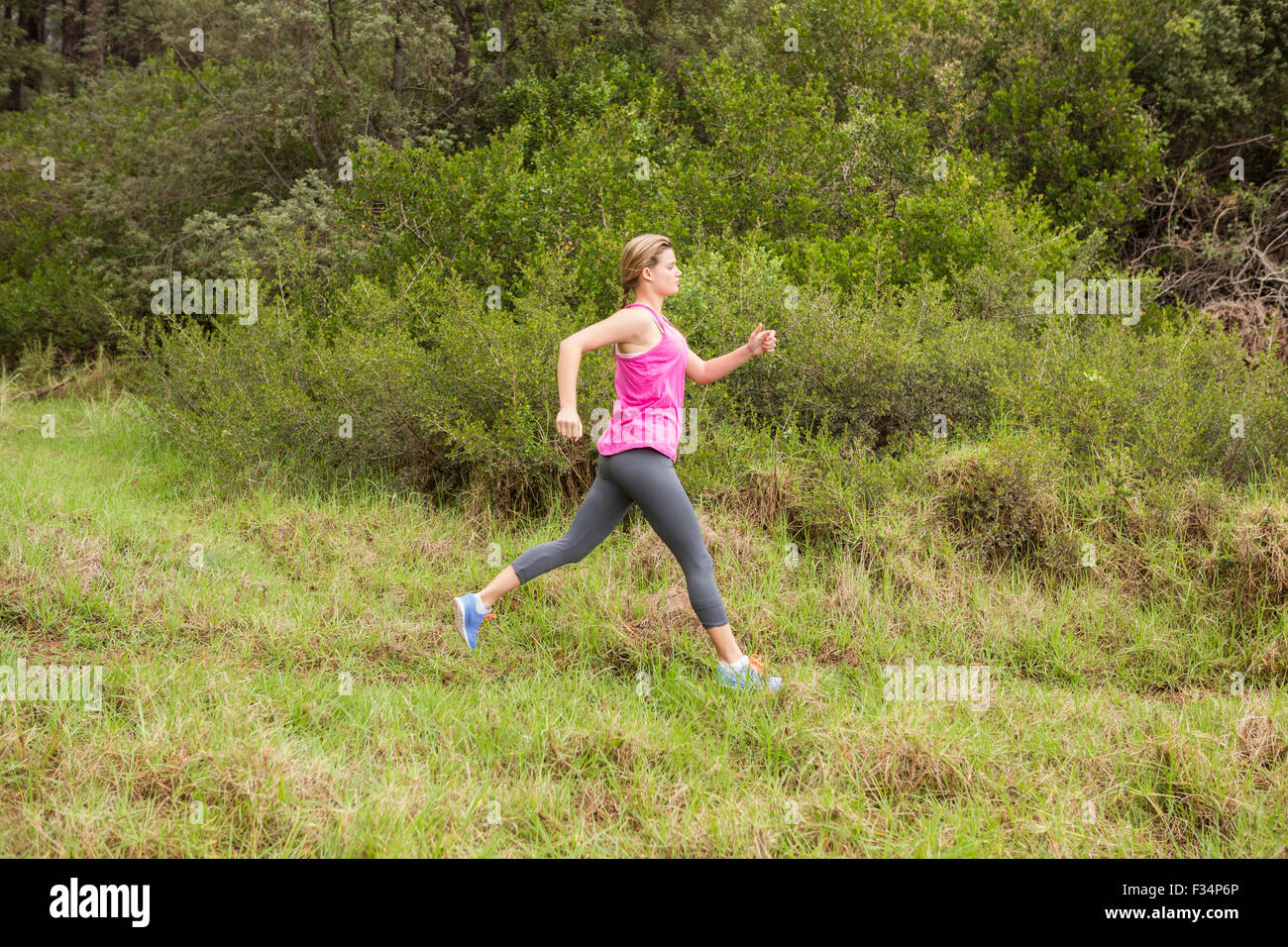 Pretty blonde athlete jogging Stock Photo - Alamy