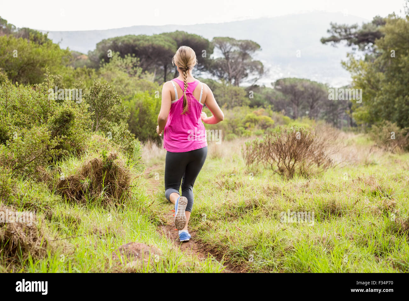 Pretty blonde athlete jogging Stock Photo - Alamy