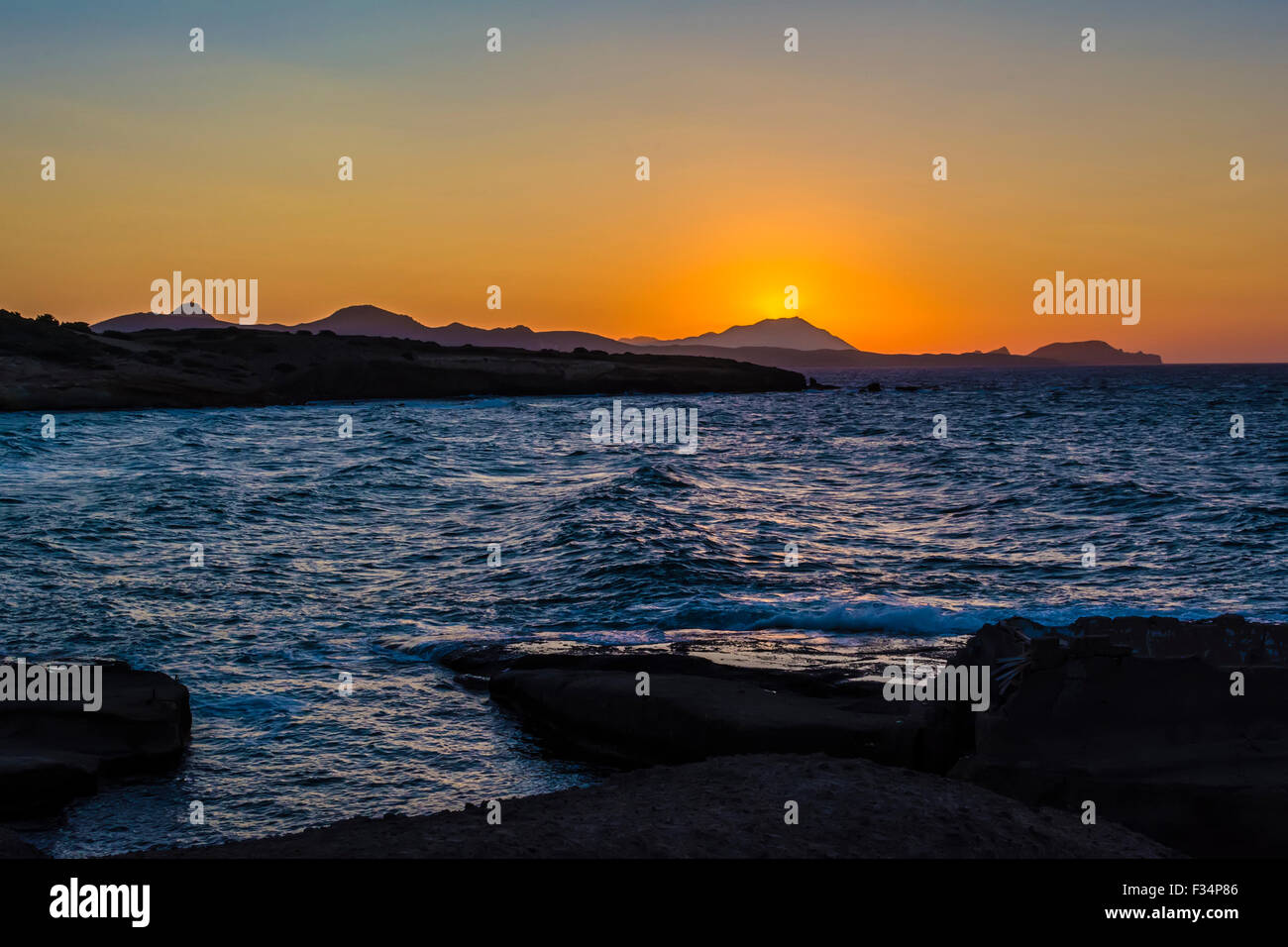 Beautiful sunset at a beach of Greek island of Milos Stock Photo - Alamy