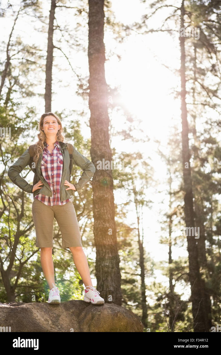 Pretty blonde hiker standing on stone Stock Photo - Alamy