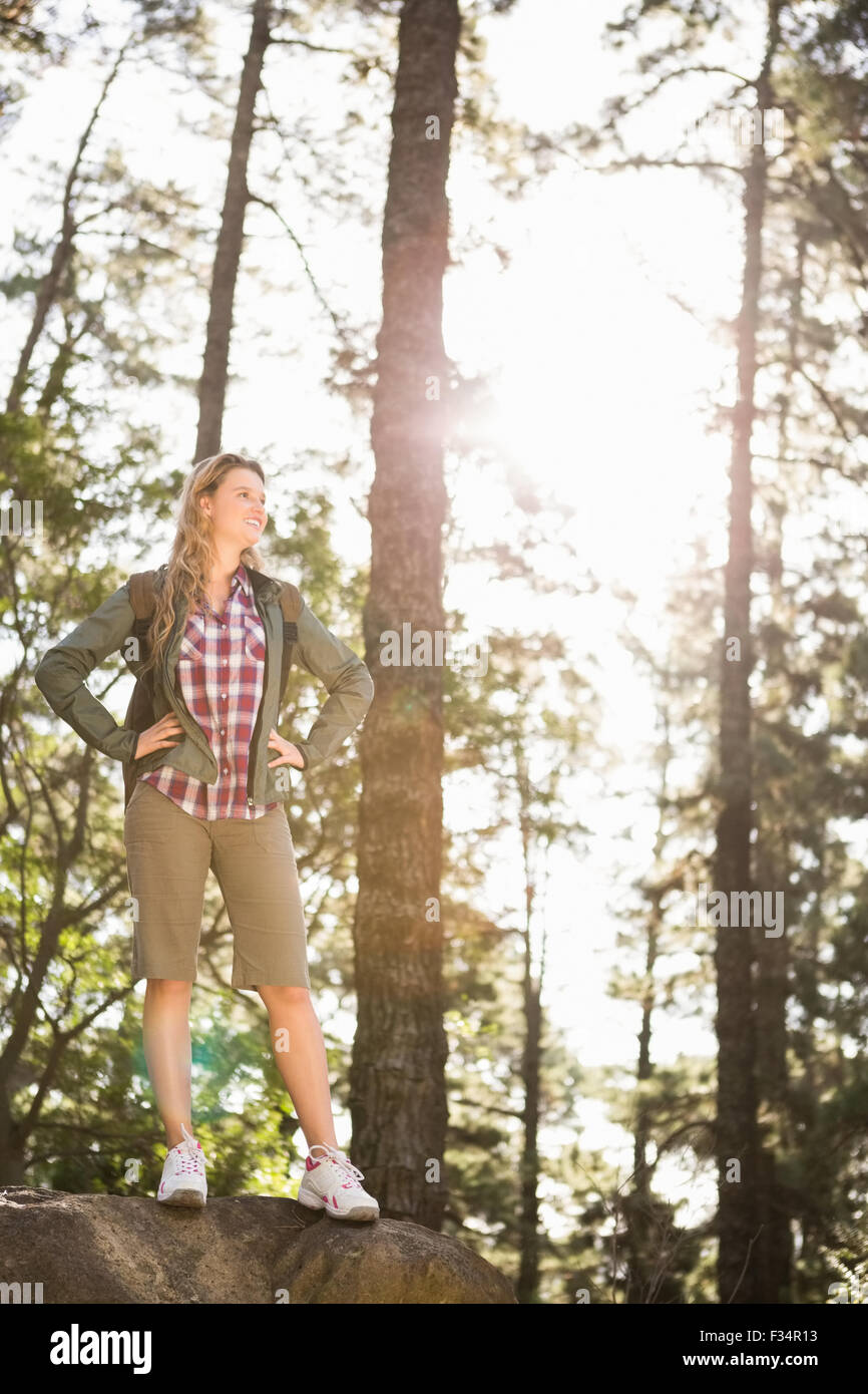 Pretty blonde hiker standing on stone Stock Photo - Alamy