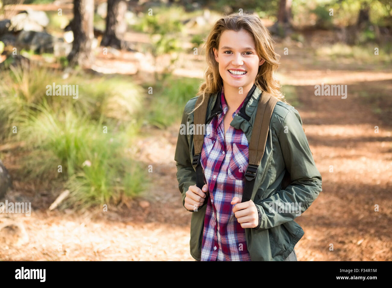 Pretty blonde hiker smiling to camera Stock Photo - Alamy