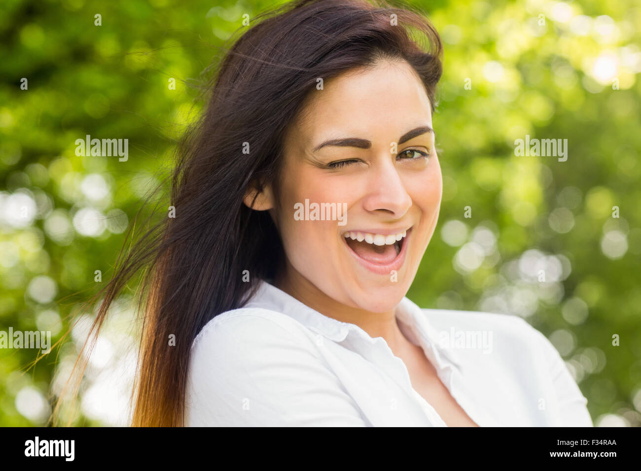 Beautiful woman winking in hi-res stock photography and images - Alamy